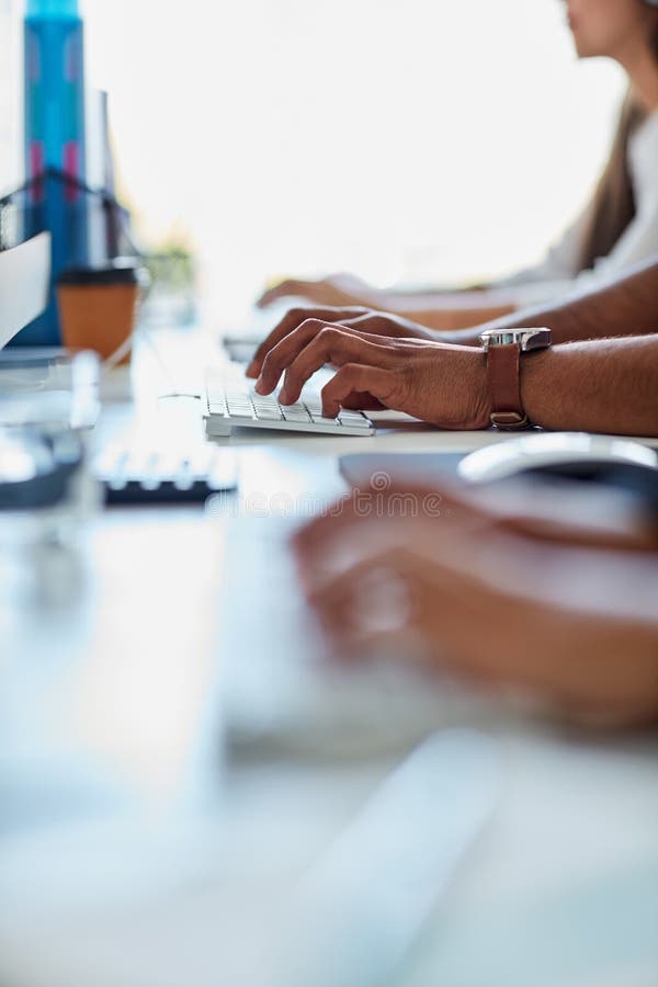 Typing Away. a Group of Workers Sitting at Their Desk. Stock Photo ...