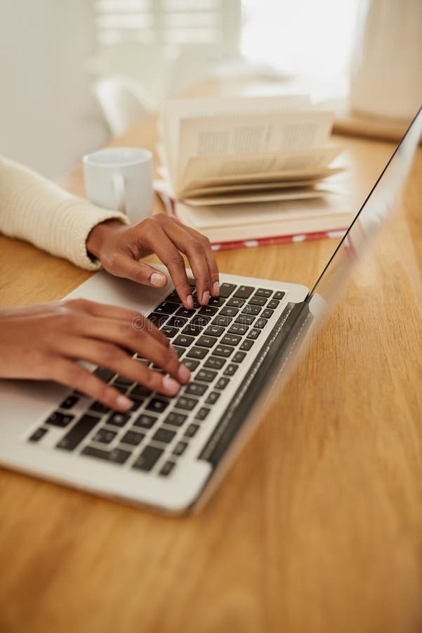 Typing Away...an Unrecognizable Woman Using Her Laptop while Sitting in ...