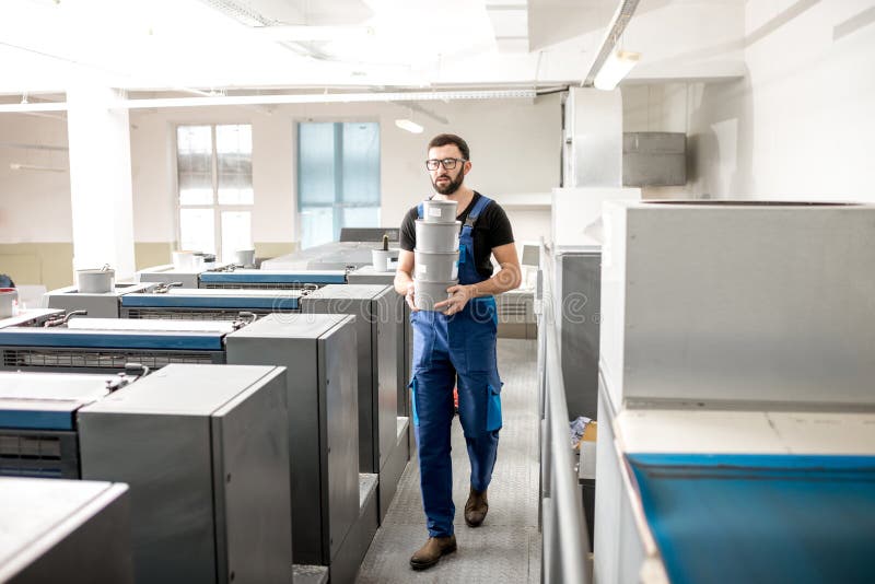 Boy Carrying Paint, Man and Woman Painting Wall in the Background ...