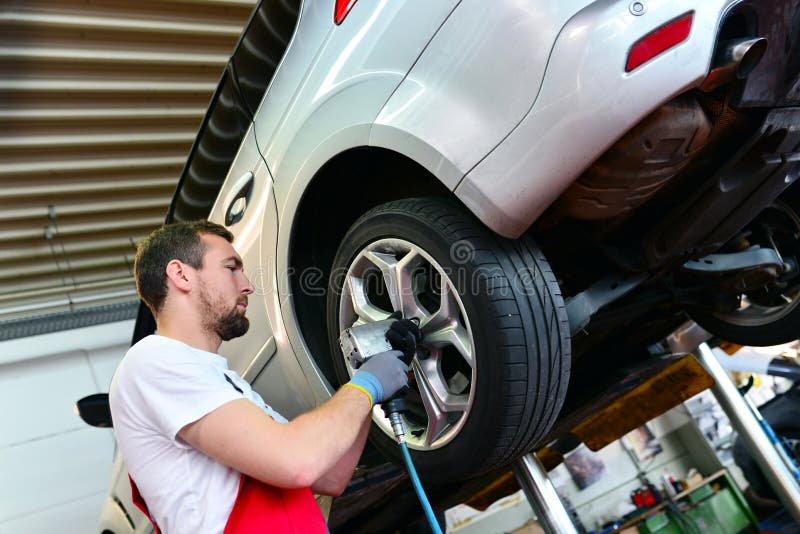 Tyre Change on the Car in a Workshop by a Mechanic Stock Photo - Image ...