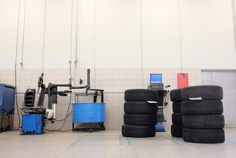 Tyre Fitting Machine and the Sets of Wheels Stock Image - Image of ...