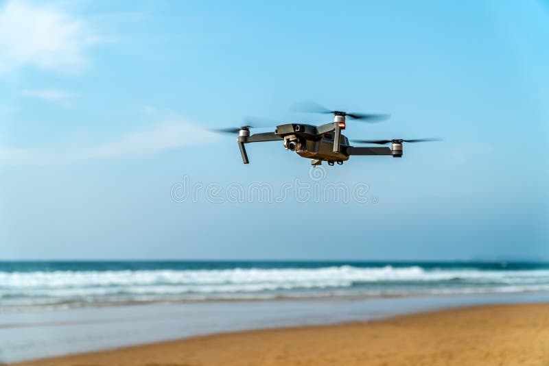 UAV Drone Quadcopter and Digital Camera Flying on Beach Stock Photo ...