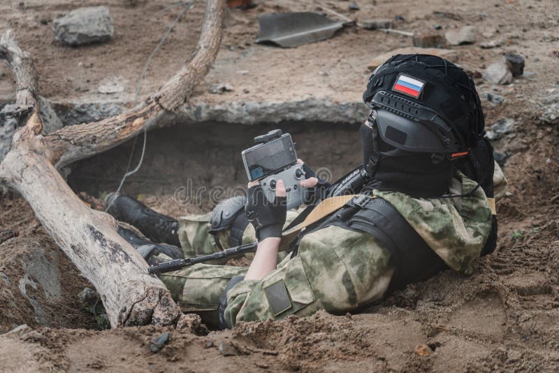 UAV Operator with a Remote Control Sitting in a Trench. Concept of ...