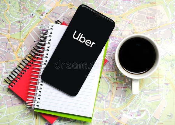 Uber Application Icon on Black Screen of Smartphone with Notebooks and ...
