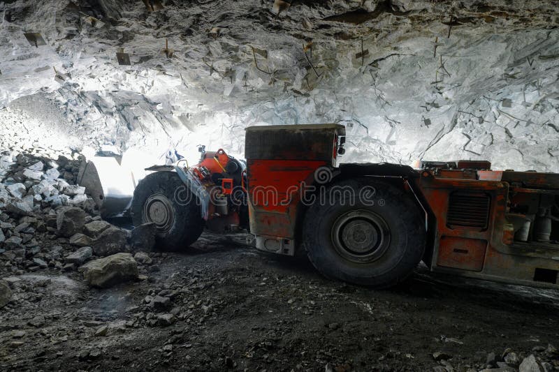 An Underground Loading Machine Carries a Full Bucket of Ore. Special ...