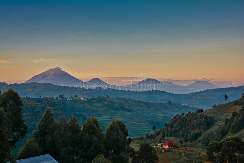 Uganda`s Muhavura Volcanoes with Morning Clouds and Layered Colored Sky ...