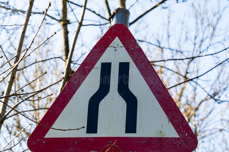 A UK Traffic Sign Stating Road Narrows Ahead with a Red and White ... A UK Traffic Sign Stating Road Narrows Ahead with a Red and White ...