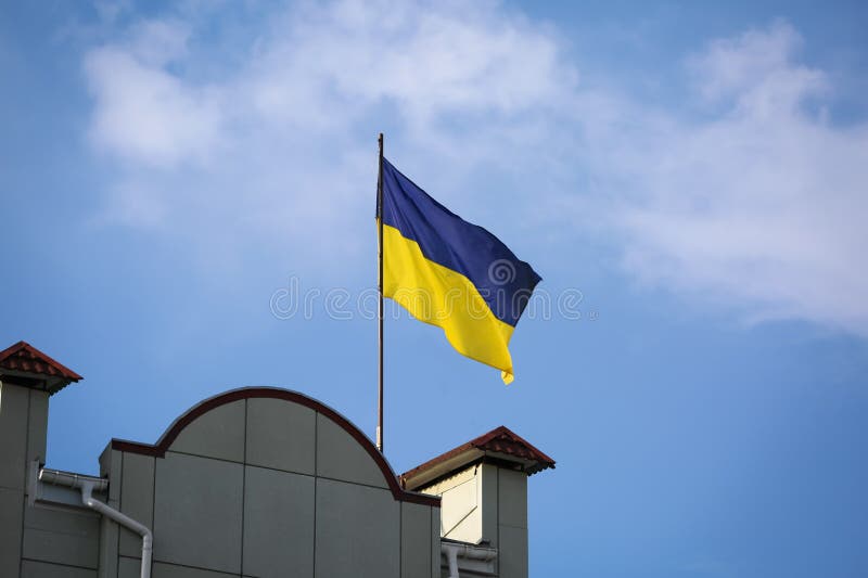 Ukrainian Flag on Building Against Blue Sky Stock Photo - Image of ...