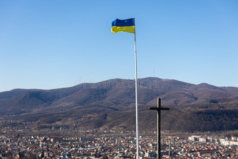 Ukrainian Flag and Cross on the Background of Mountains. Stock Image ...