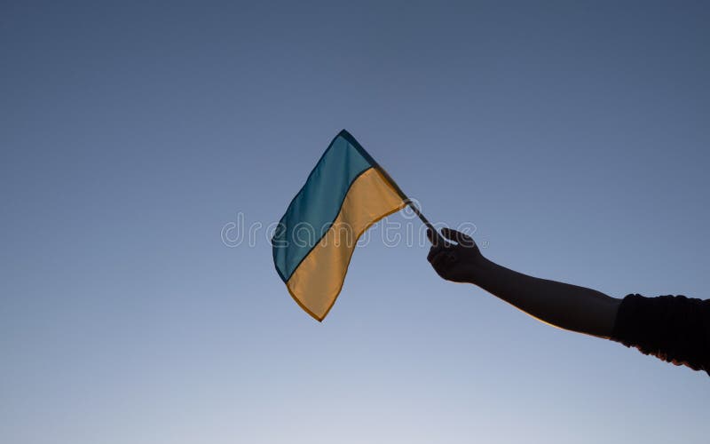 Ukrainian Flag in Hand Over Clear Blue Sky Stock Photo - Image of ...
