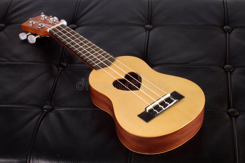 Ukulele on black leather stock photo. Image of rock, instrument - 56315836