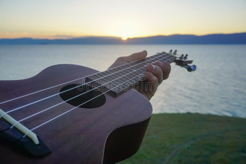 Ukulele in the Hand of a Man at Sunset Stock Photo - Image of hobby ...
