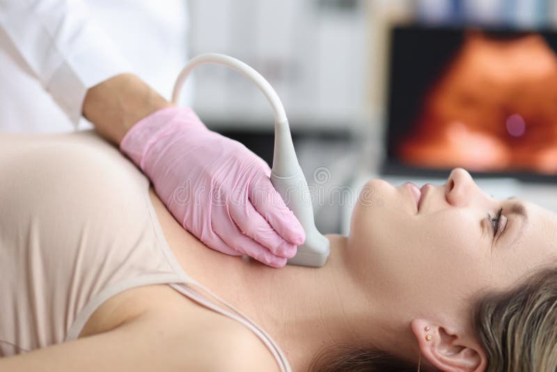 Ultrasound Diagnosis Of Thyroid Gland In Young Woman In Clinic Stock