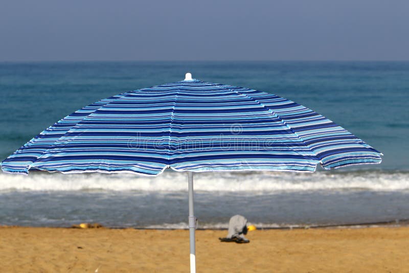 Umbrella by the sea stock image. Image of shade, recreation - 128352587