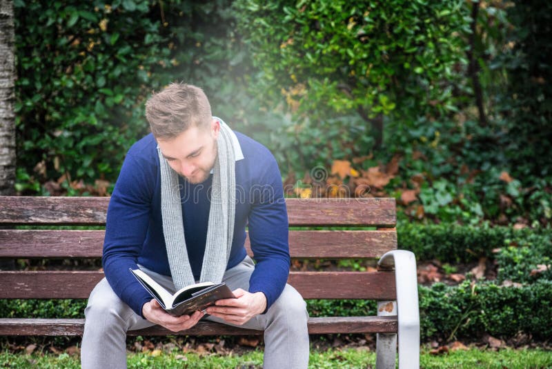 Un Joven Sentado En Una Banca Del Parque Leyendo Un Libro Imagen de ... Un Joven Sentado En Una Banca Del Parque Leyendo Un Libro Imagen de ...