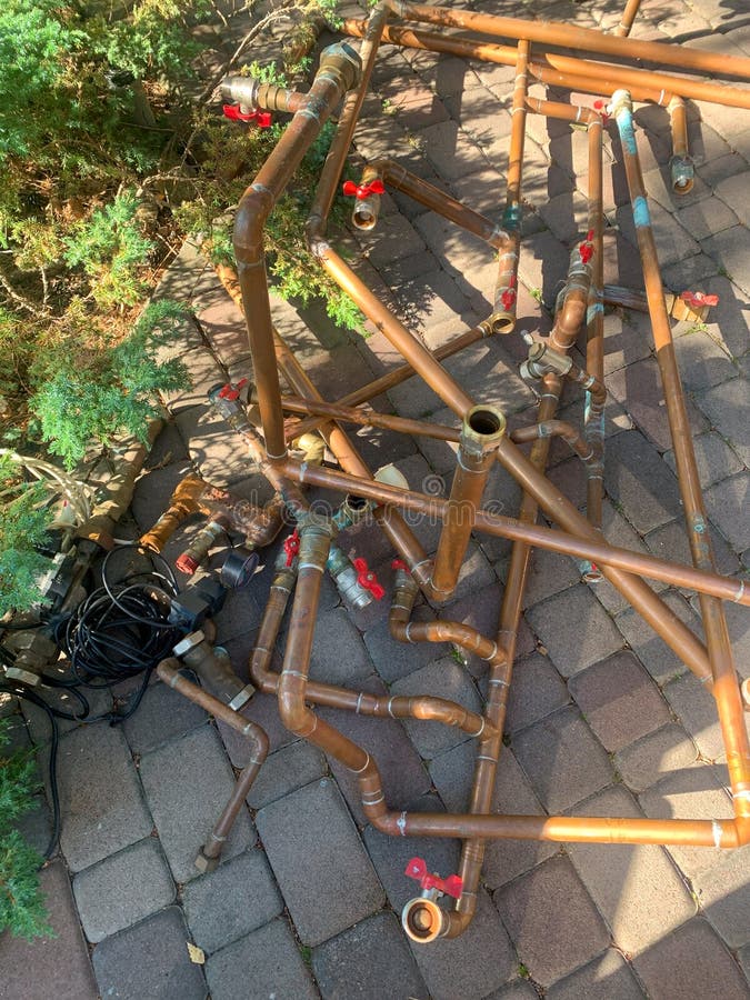 Unassembled Copper Piping Layout on a Patio Stock Image - Image of ...