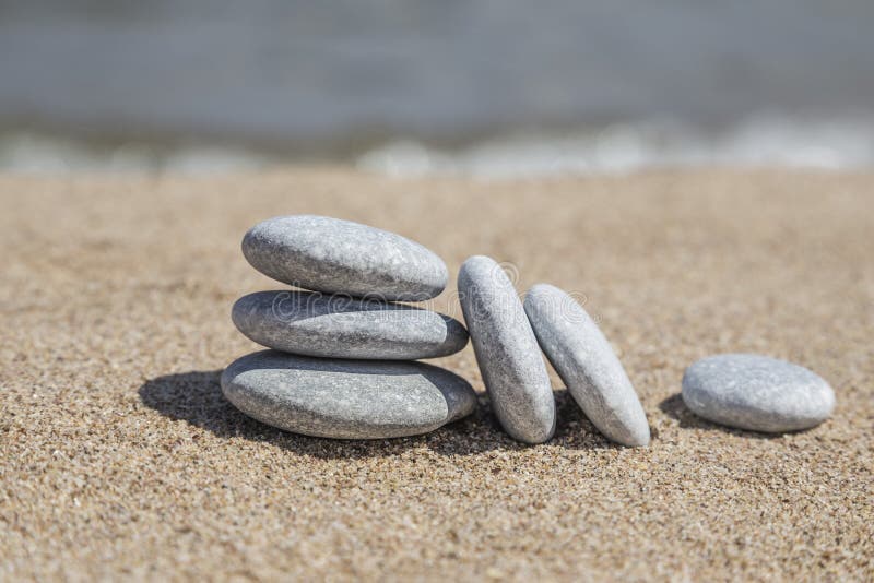 Unbalanced stones on beach stock photo. Image of simplicity - 70849802