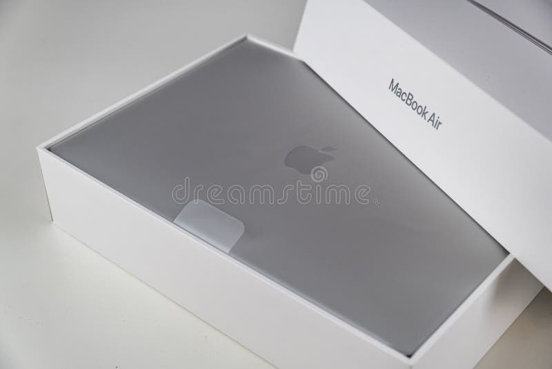 Unboxing a Silver Macbook Air on a White Table. Apple Laptop Editorial ...