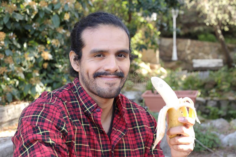 Uncomfortable Looking Man Eating a Banana Stock Photo - Image of ...