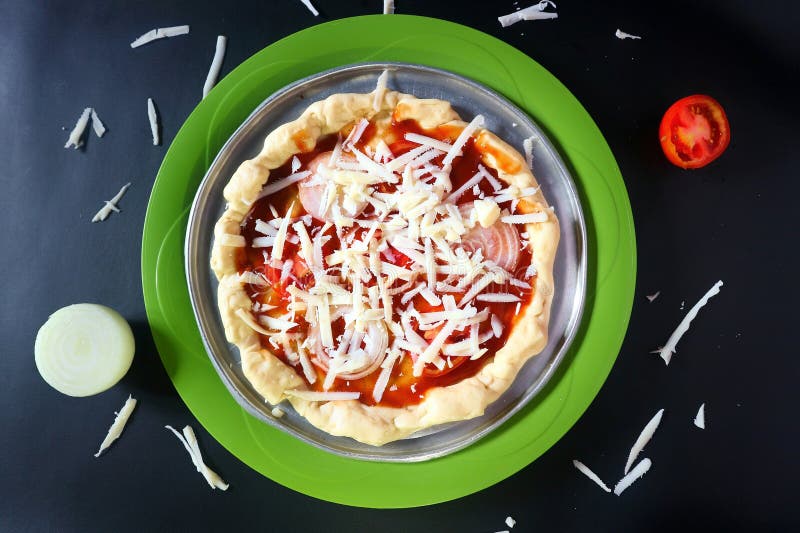 Uncooked Delicious Homemade Pizza on Black Table. Top View of a Simple ...