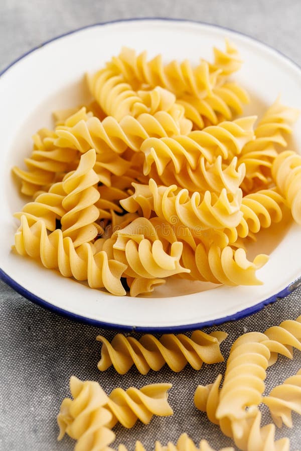 Uncooked Fusilli Pasta. Uncooked Italian Pasta on Plate Stock Photo ...