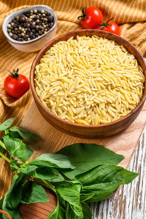 Uncooked Orzo Paste. Recipe for Risoni with Basil Leaves, Tomatoes and ...