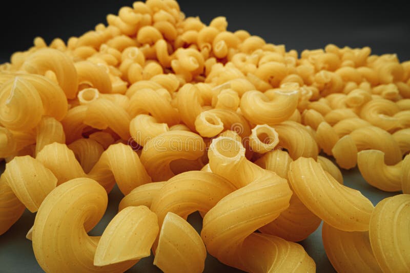 Uncooked Pasta Swirls on Dark Background Macro Stock Image - Image of ...