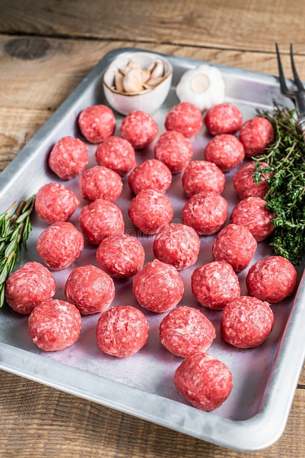Uncooked Raw Meatballs From Ground Beef And Pork Meat With Rosemary