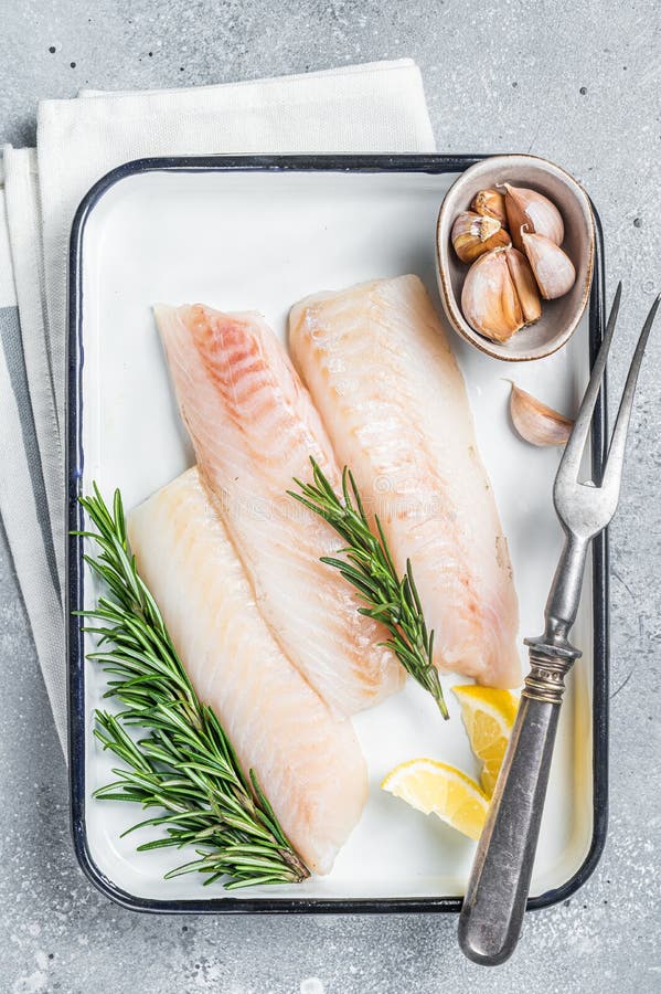 Uncooked Raw Cod Loin Fillet Steaks with Herbs in Kitchen Tray. Gray ...