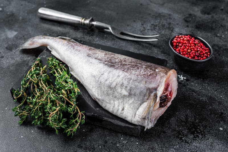 Uncooked Raw Cod Whole Fish on Marble Board with Thyme. Black ...