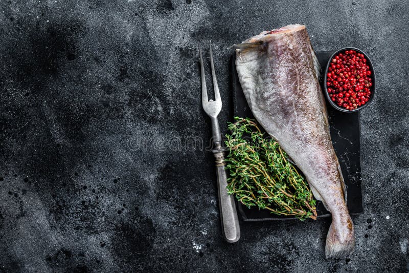 Uncooked Raw Cod Whole Fish on Marble Board with Thyme. Black ...