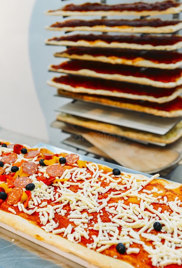 Uncooked Rectangular Roman Style Pizza with Salami Topping Stock Photo ...