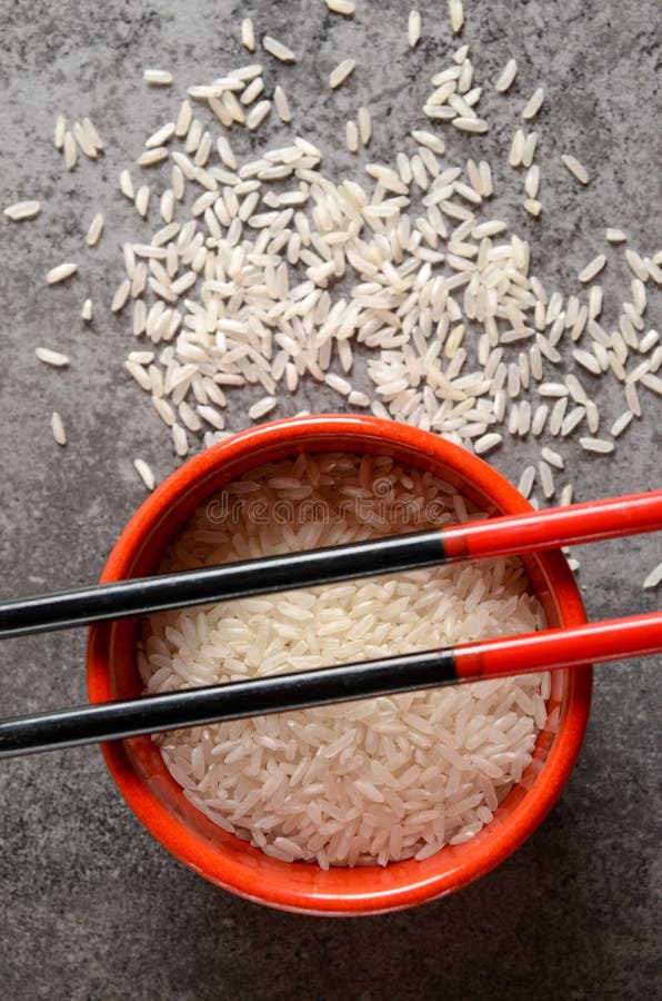 Uncooked rice in a bowl stock image. Image of view, texture - 52624317