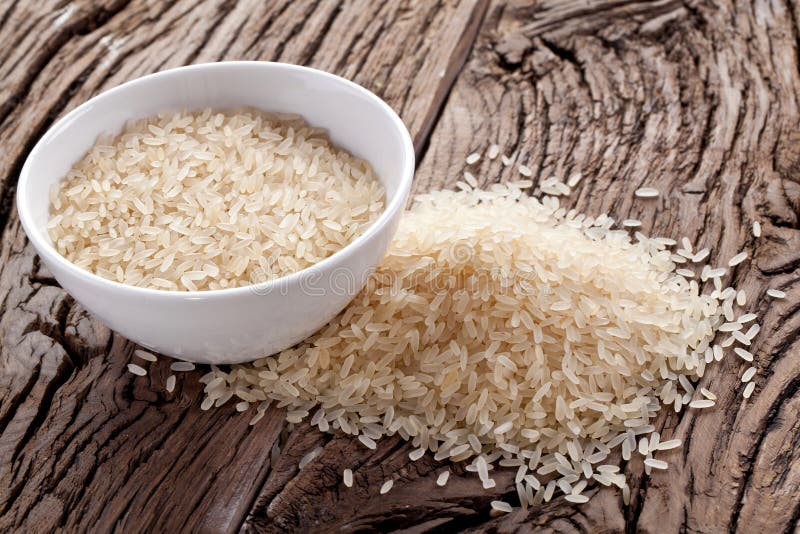 Uncooked rice in a bowl stock image. Image of natural - 33687483