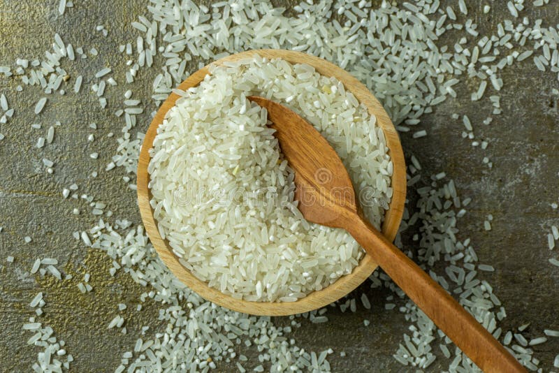 Uncooked Rice or Dry Rice. Raw Rice in Wooden Bowl with Wooden Spoon ...
