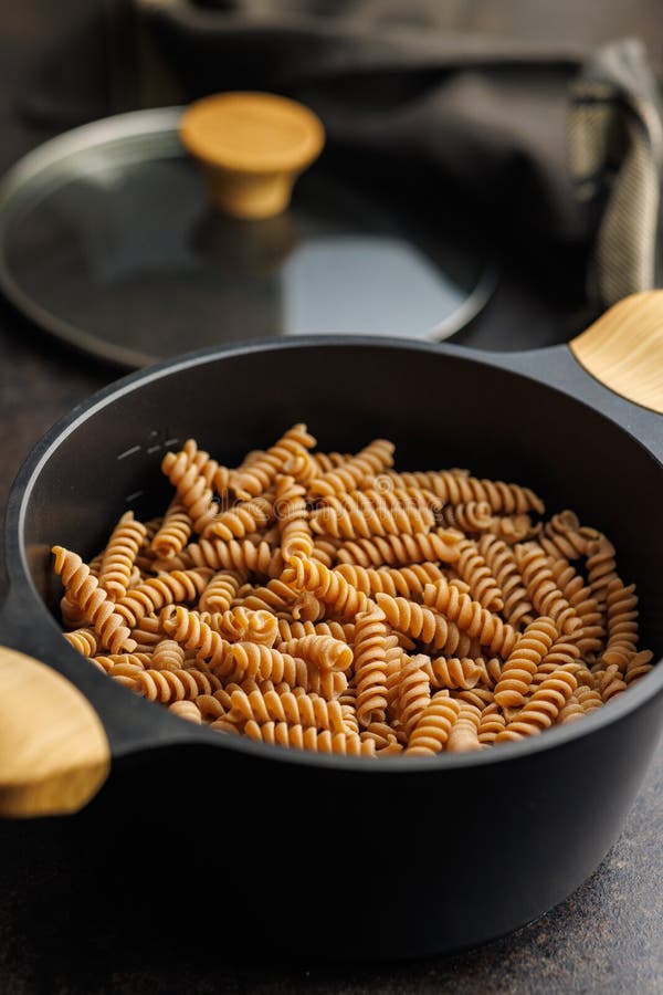 Uncooked Whole Grain Pasta. Raw Fusilli in Black Pot Stock Image ...
