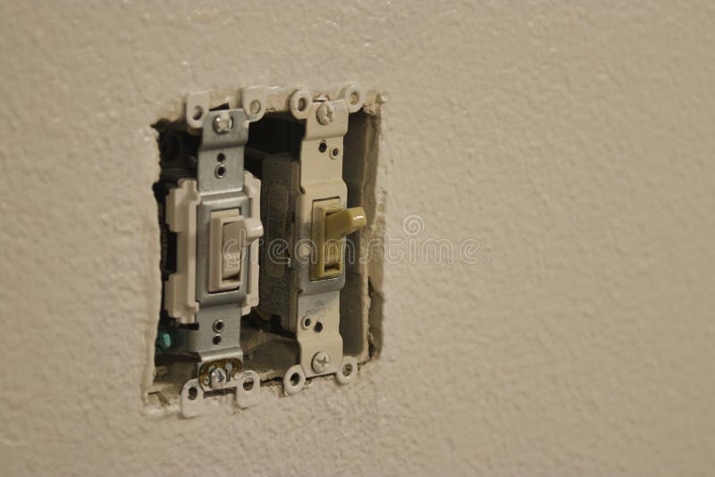 Uncovered Light Switches in a White Wall Stock Photo - Image of switch ...