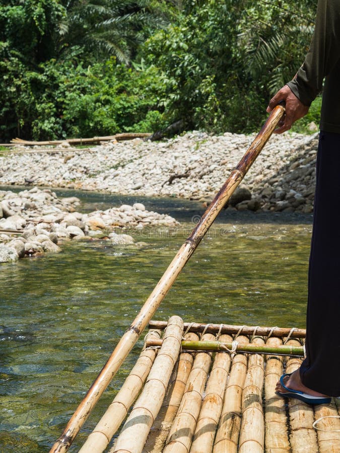 Undefined Man Drives a Makeshift Raft Sailing Along a River in the ...