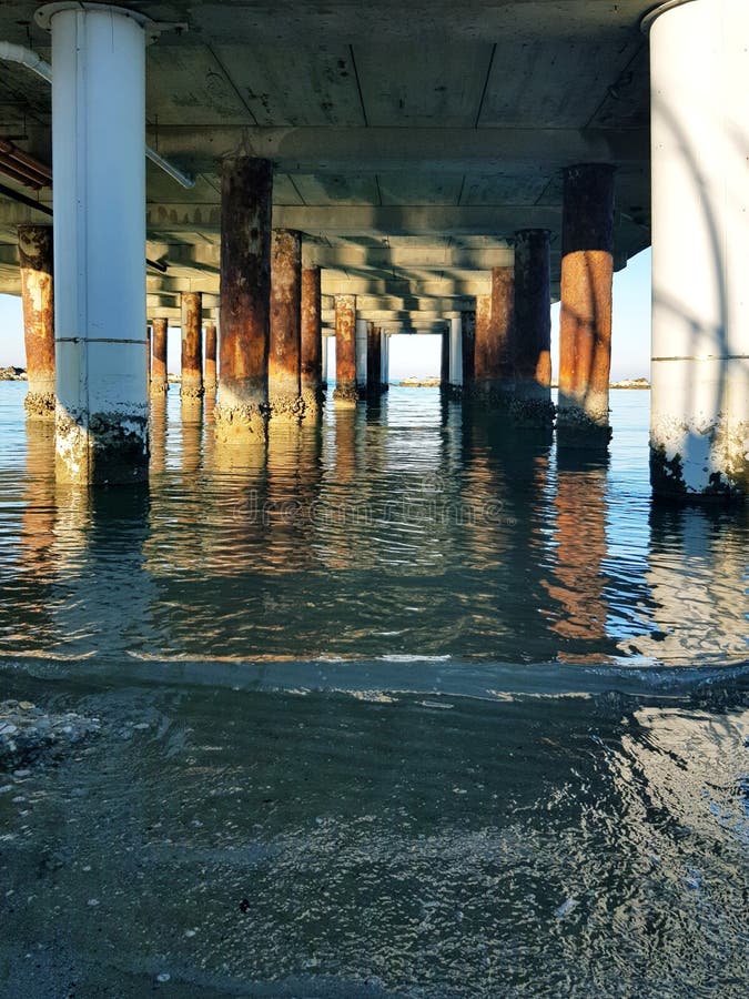 Under the Bridge Over the Sea in the Rays of the Setting Sun Stock ...