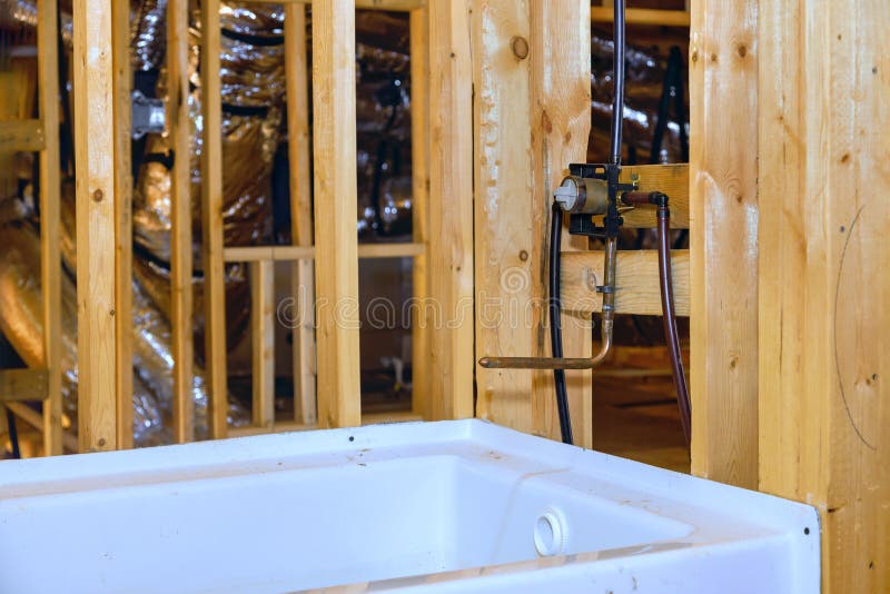 A Under Construction Home with Installed New Acrylic Bathtub between ...
