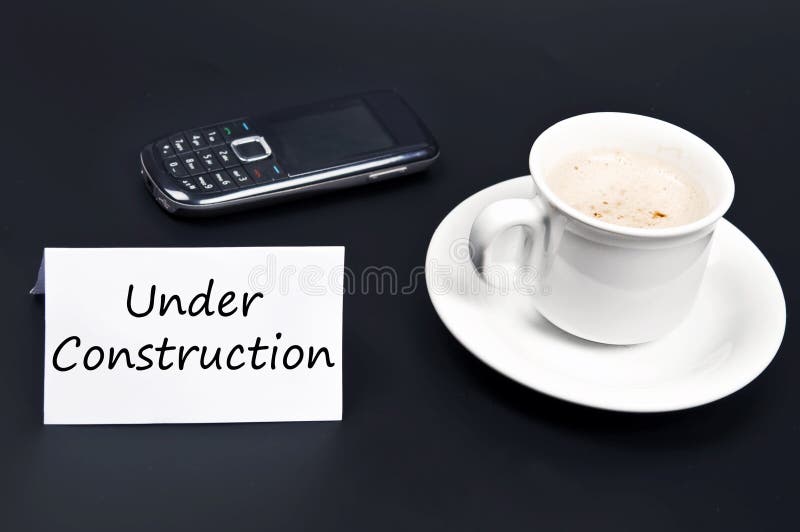 Under Construction Message on Desk with Coffee Stock Photo - Image of ...