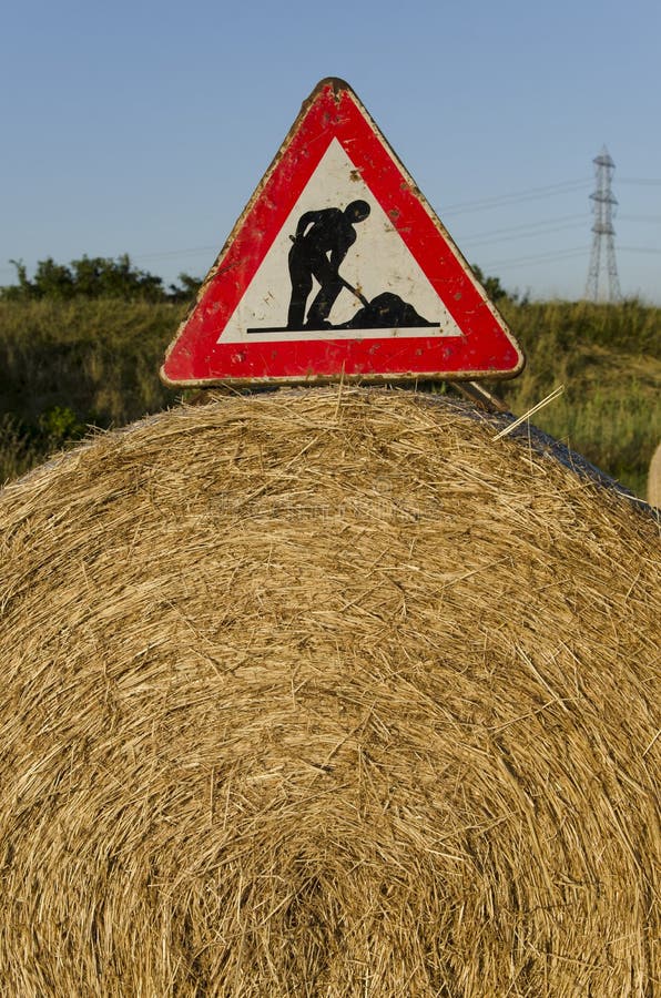 Under Construction Sign with Straw Round Bale Stock Photo - Image of ...