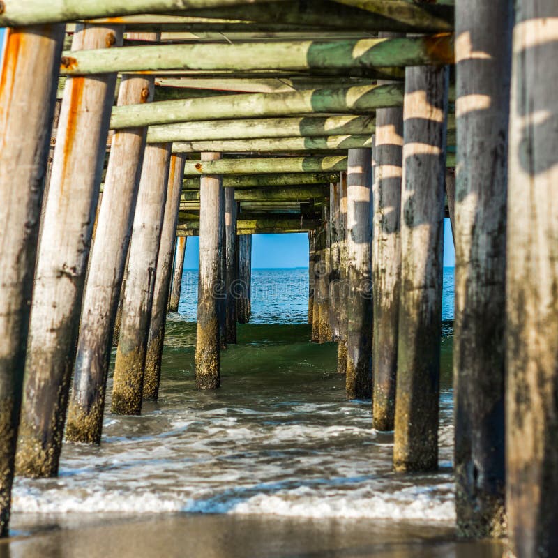 Under the dock stock photo. Image of pier, pole, water - 65574846