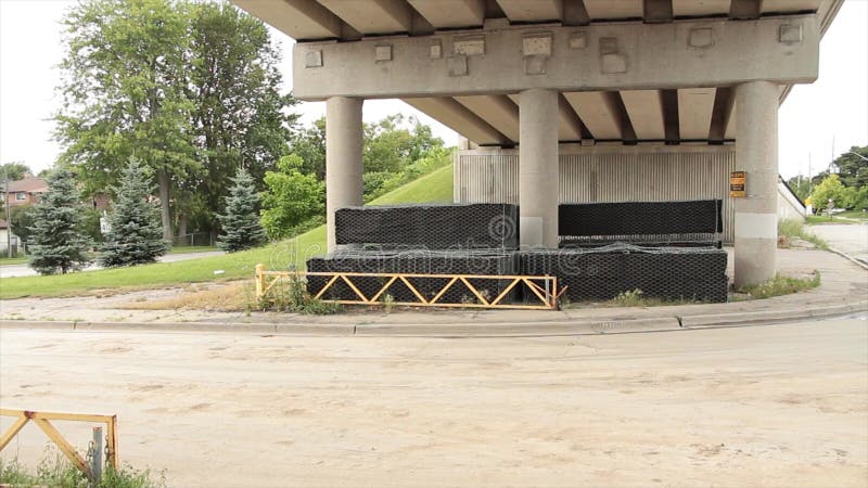 Under Large Bridge Underpass with Road and Trees To Side and Sky in ...