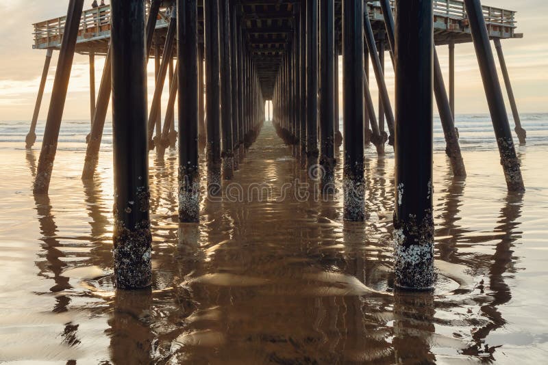 Under the Pier. High Tide on the Beach at Sunset Stock Photo - Image of ...