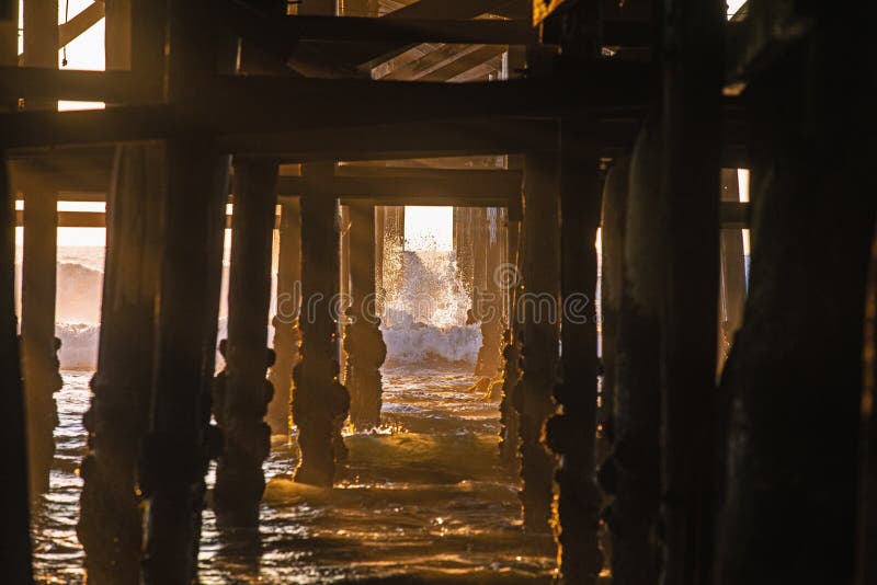 Under the pier at sunset stock photo. Image of ocean - 173451486