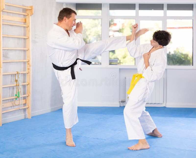 Underage Boy and Middle-aged Man Performing Karate Techniques in Pair ...