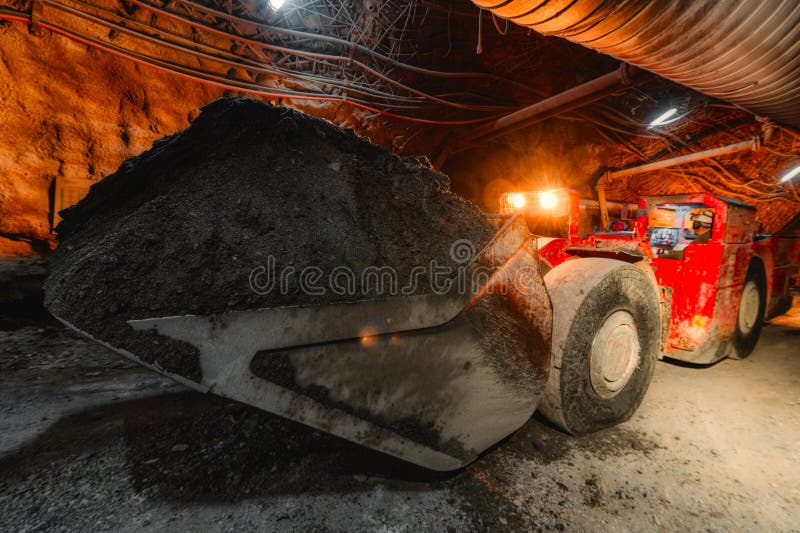An Underground Loading Machine Carries a Full Bucket of Ore. Special ...