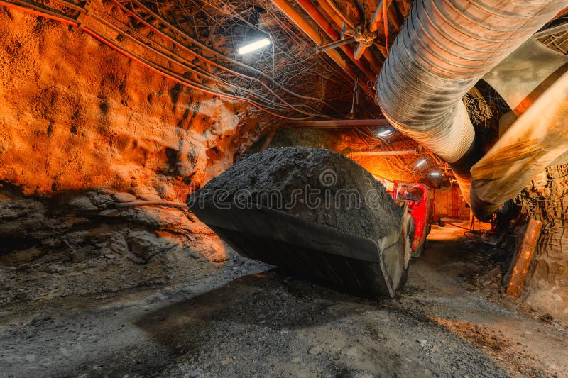 An Underground Loading Machine Carries a Full Bucket of Ore. Special ...