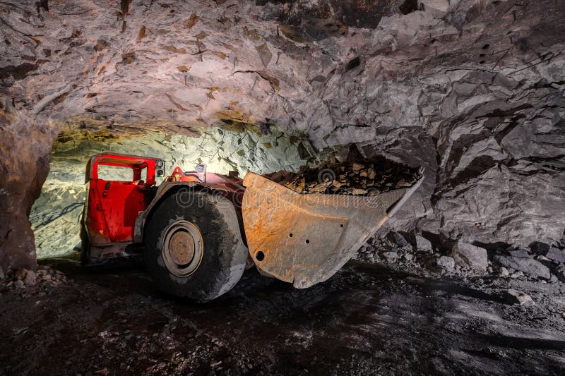 An Underground Loading Machine Carries a Full Bucket of Ore. Special ...